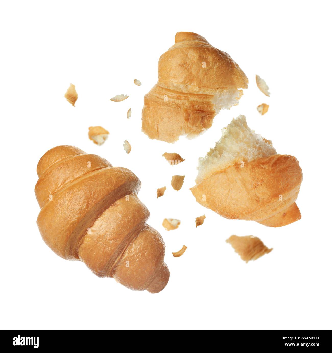 Delicious fresh croissants falling on white background Stock Photo - Alamy