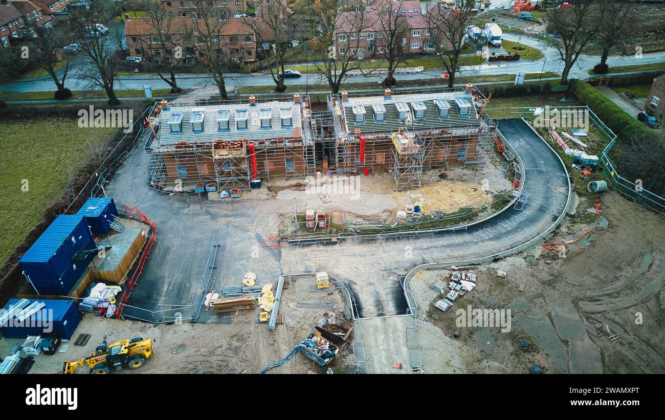 Aerial view of a residential construction site with scaffolding and ...