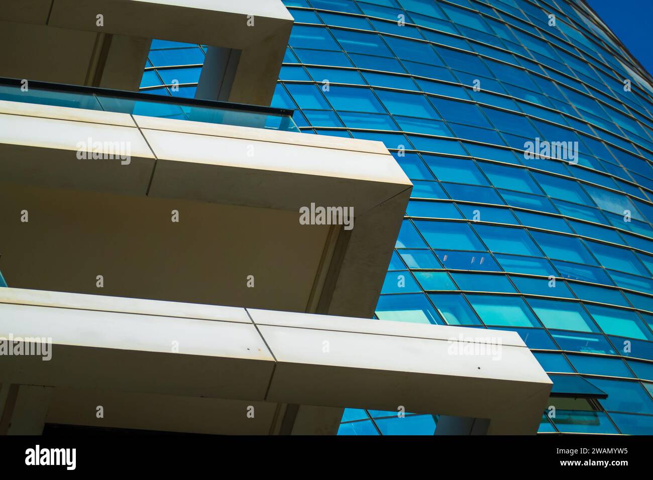 Abstract close-up of a modern glass building with reflective windows ...