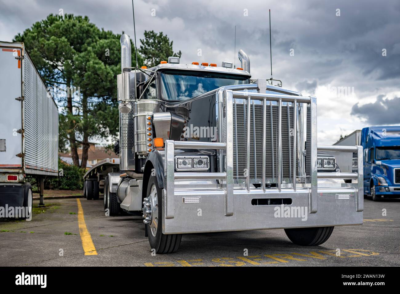 Industrial black powerful big rig semi truck tractor with huge grille ...