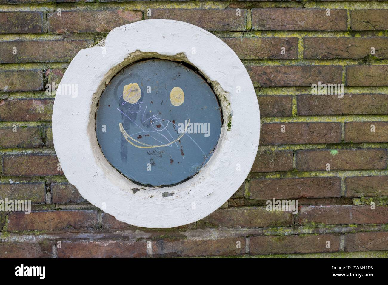 Round concrete windows or port holes mounted into the brick base of the ...