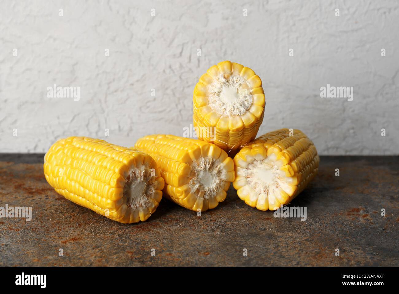 Cut fresh corn cobs on dark table Stock Photo - Alamy