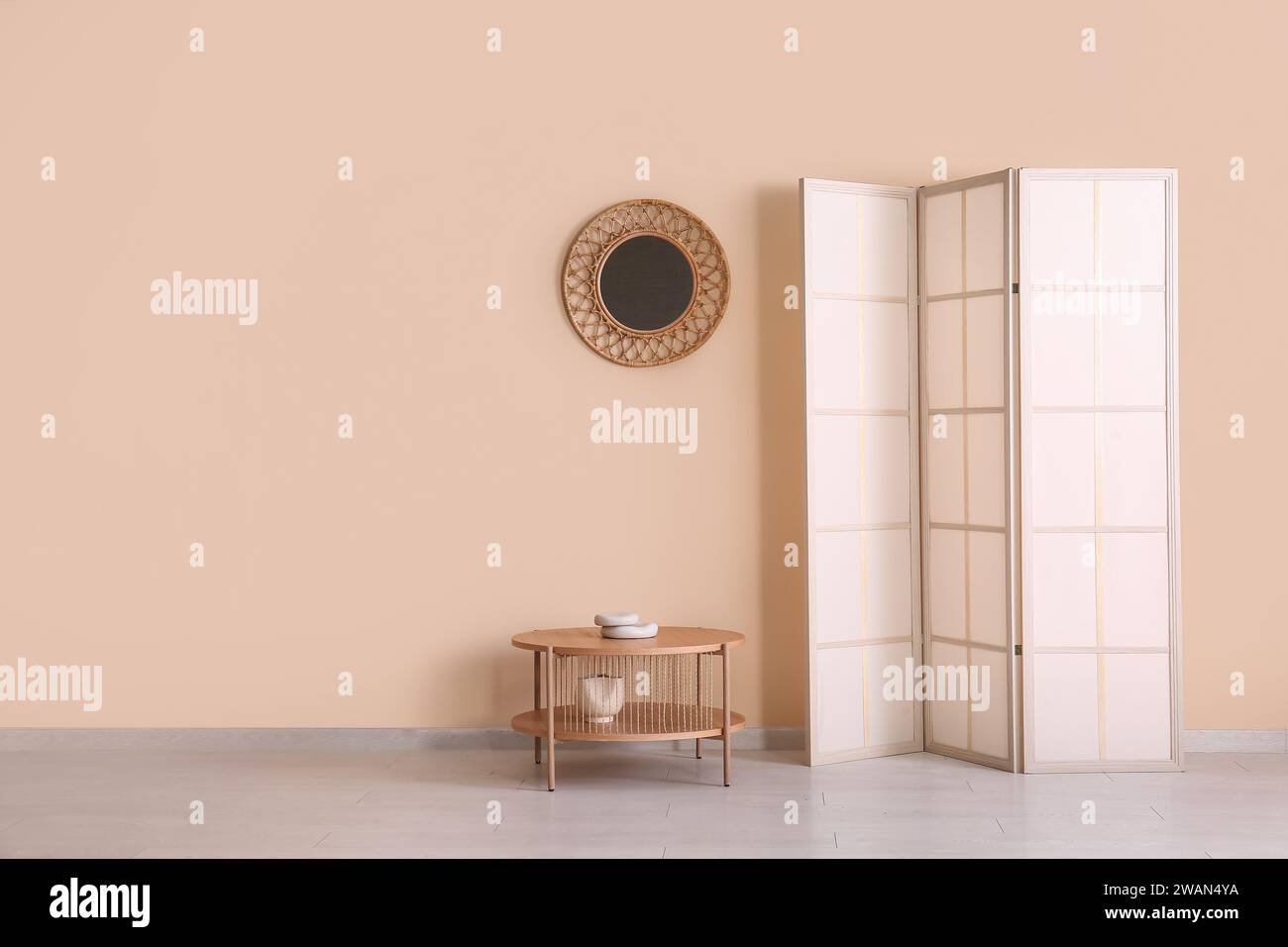 Folding screen, mirror and coffee table near colorful wall Stock Photo ...