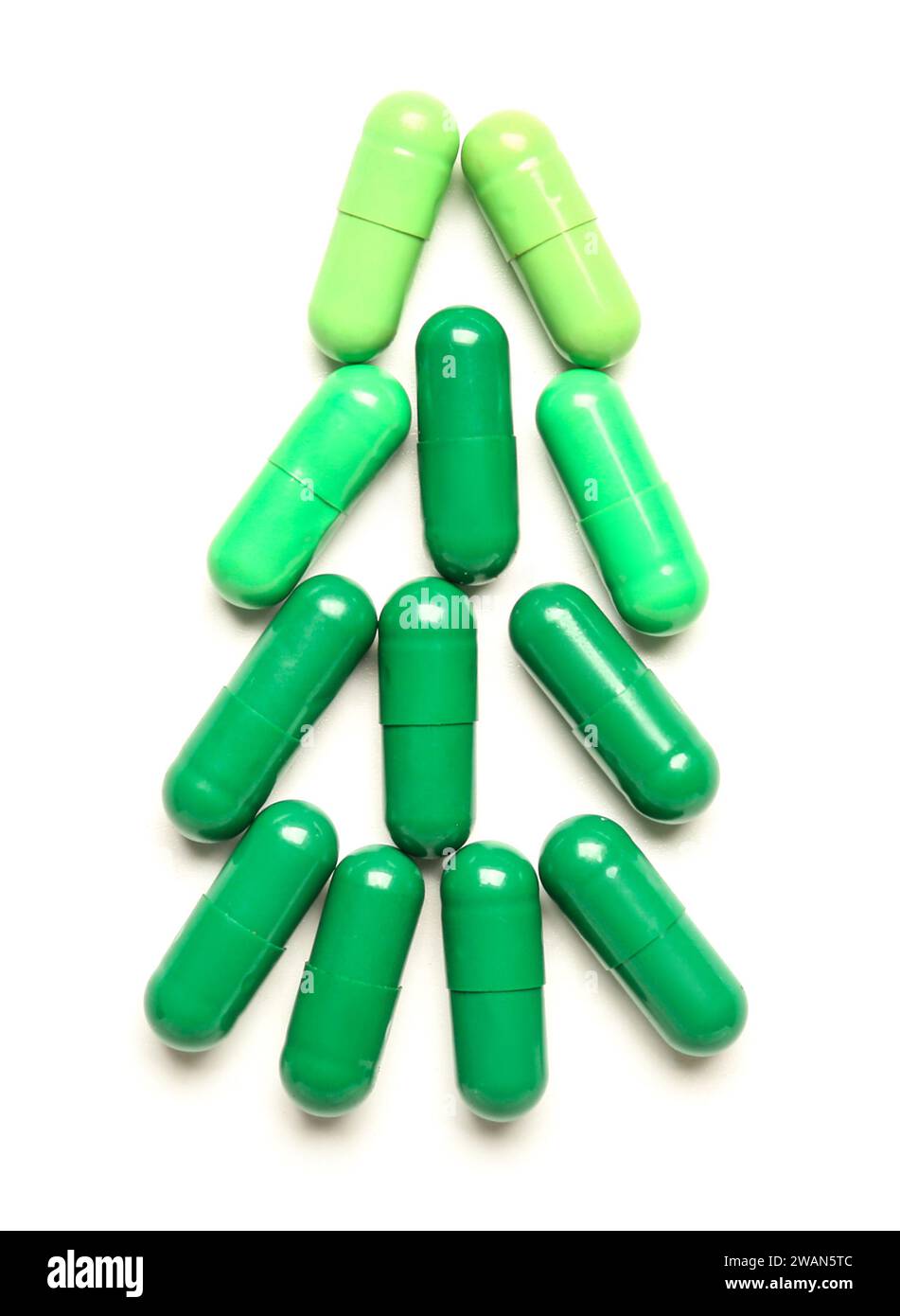Christmas tree made of capsules on white background Stock Photo - Alamy