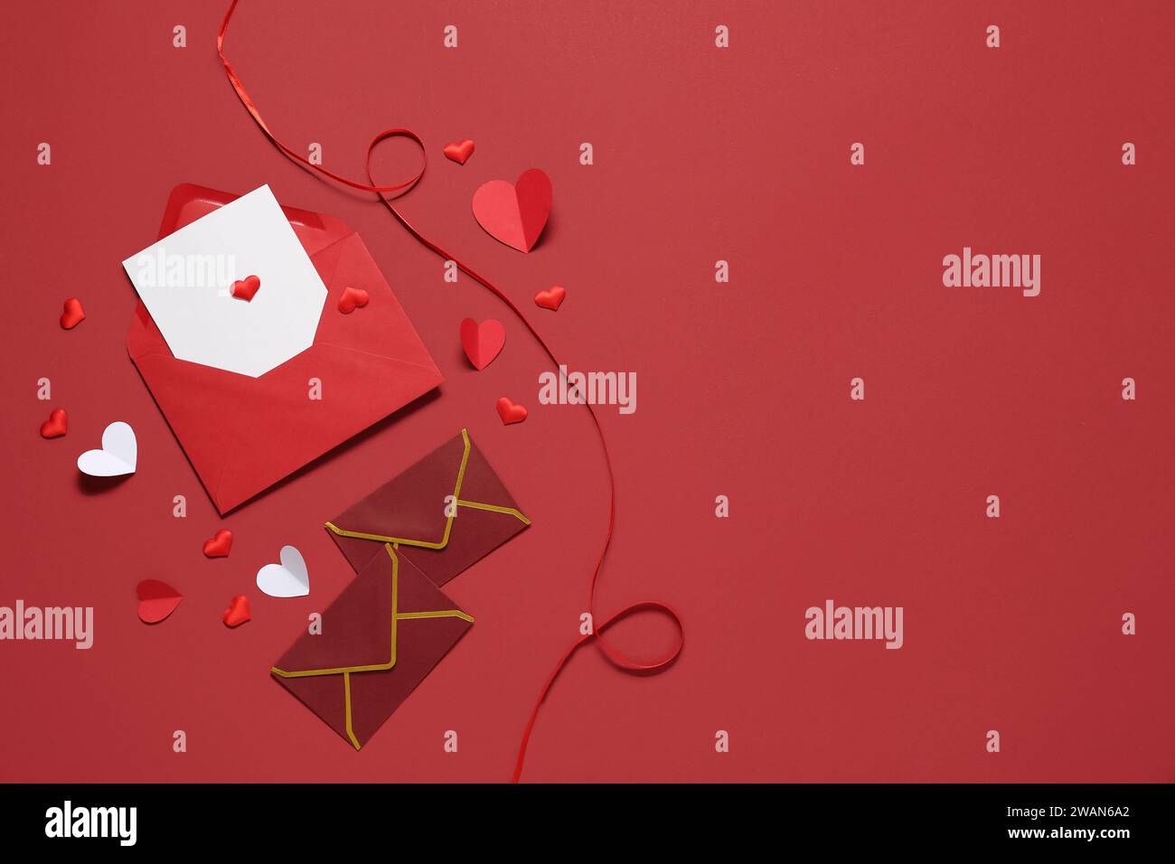 Composition with envelopes, blank card, ribbon and paper hearts on ...
