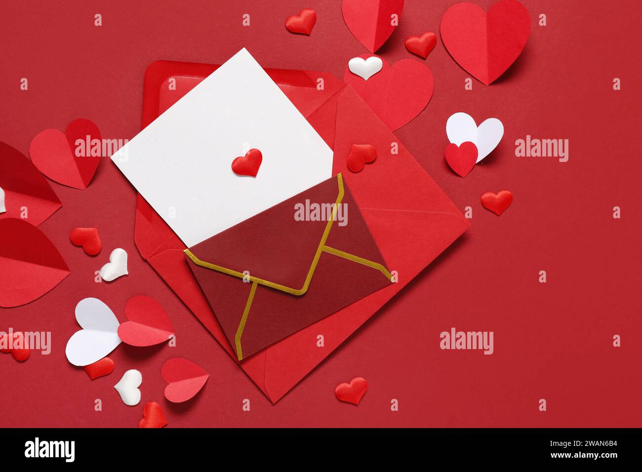 Composition with envelopes, blank card and paper hearts on color ...