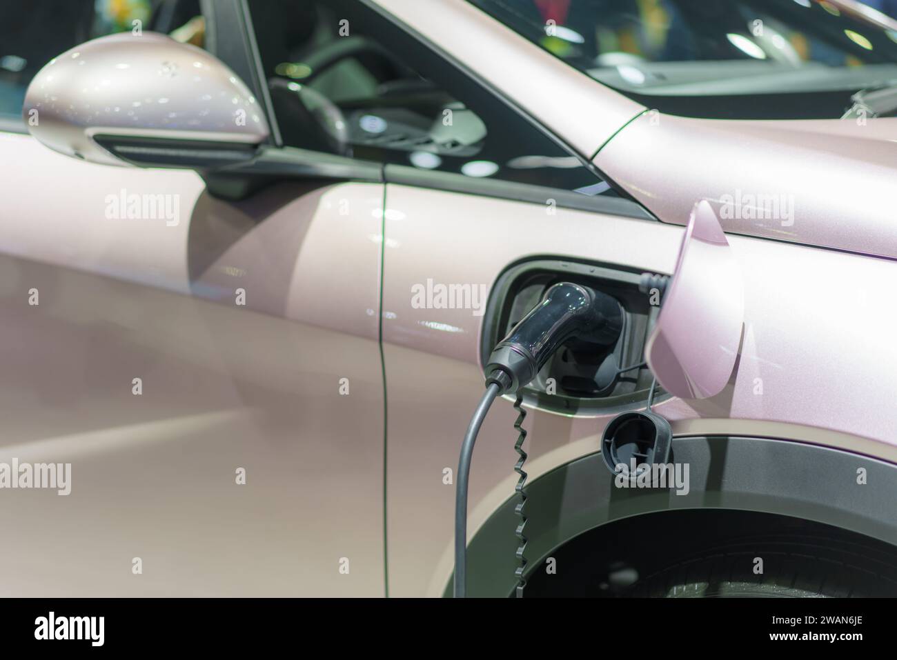 EV car at rest, connected to a charging station, embodying the ...