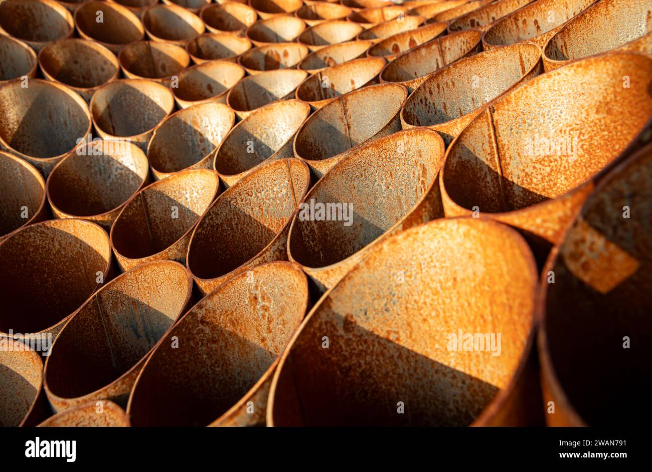 Rusty iron, Symmetrical metal pipes under the sun, with light shadow ...