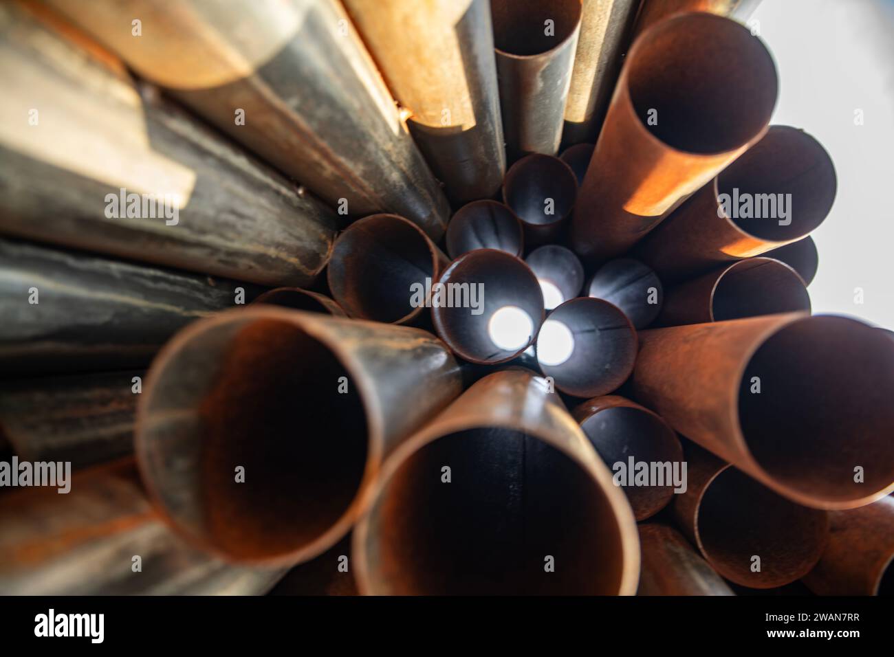 Rusty iron, Symmetrical metal pipes under the sun, with light shadow ...