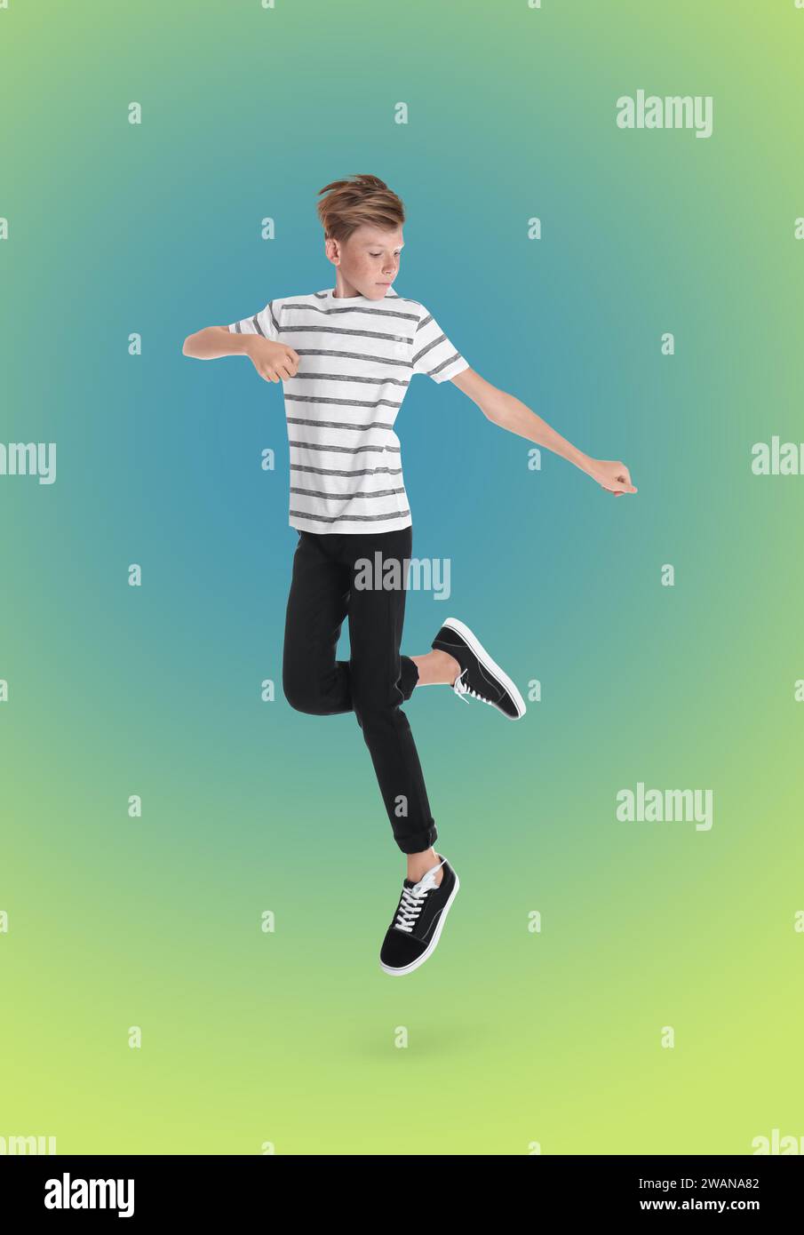 Teenage boy jumping on color gradient background Stock Photo - Alamy