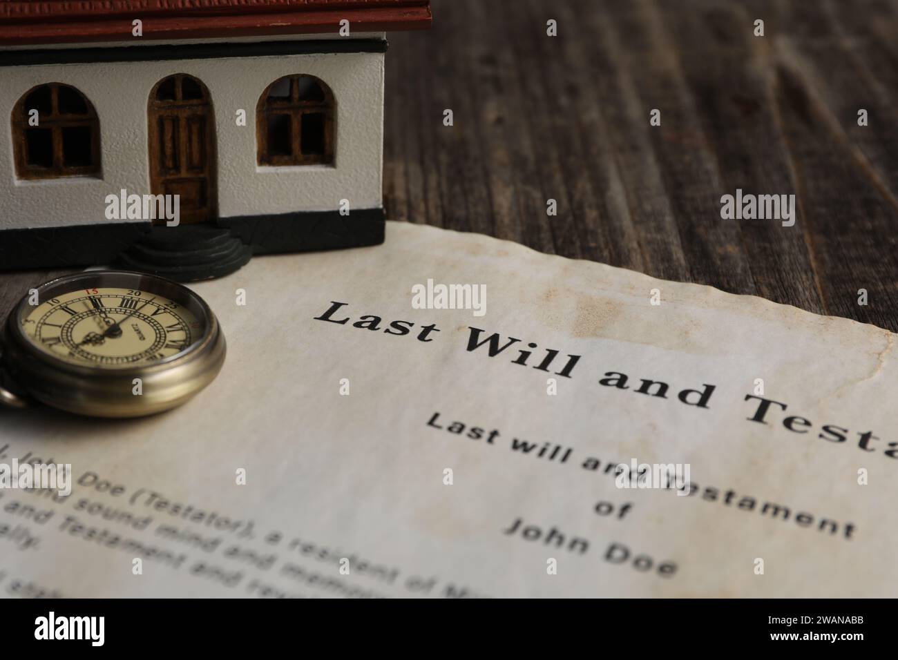 Last Will and Testament with pocket watch and house model on wooden ...