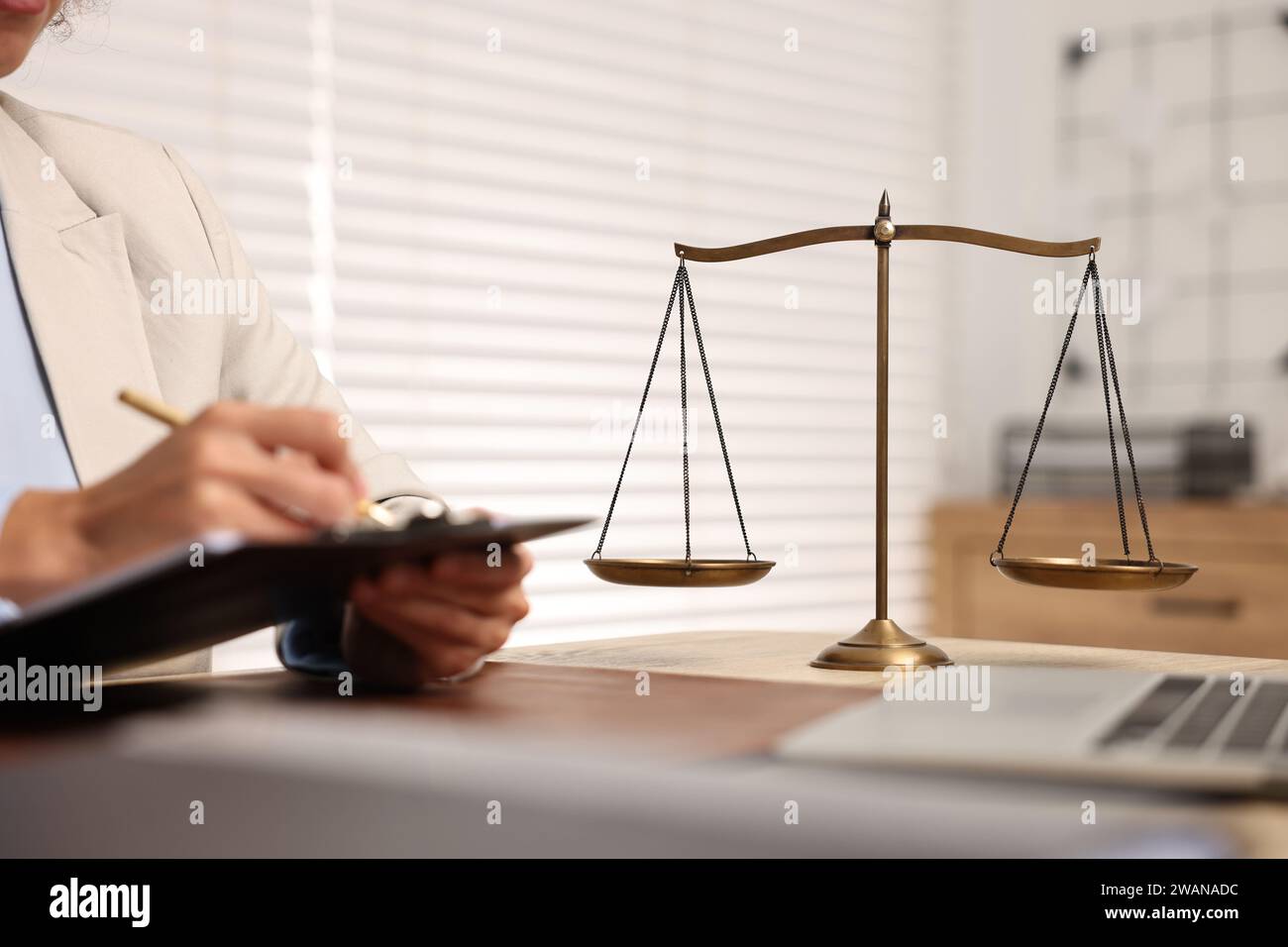 Notary with clipboard writing notes at workplace in office, focus on ...