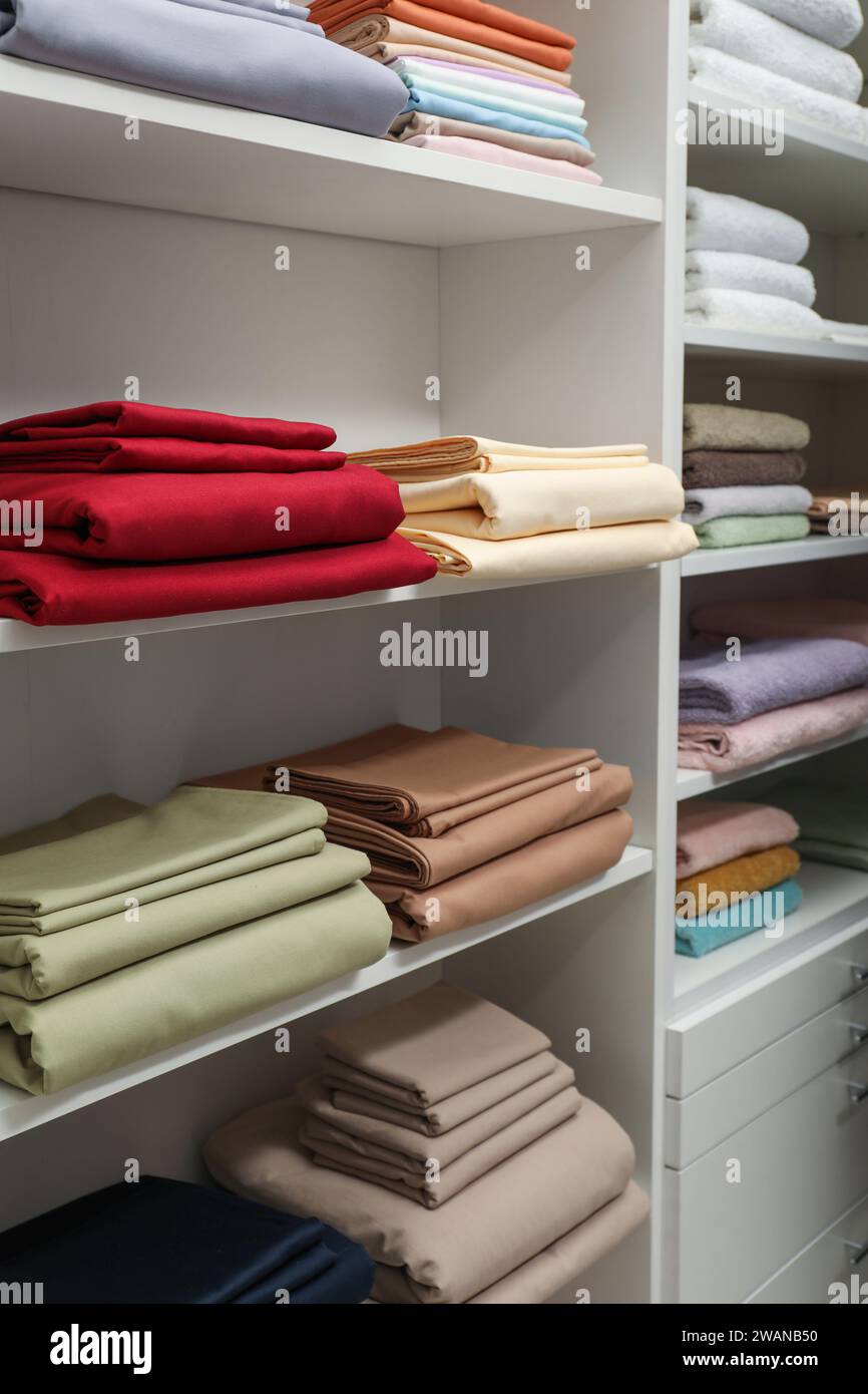Different colorful bed linens on display in home textiles store Stock ...