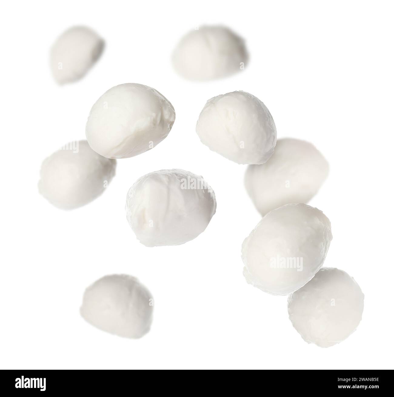 Fresh mozzarella balls falling on white background Stock Photo - Alamy