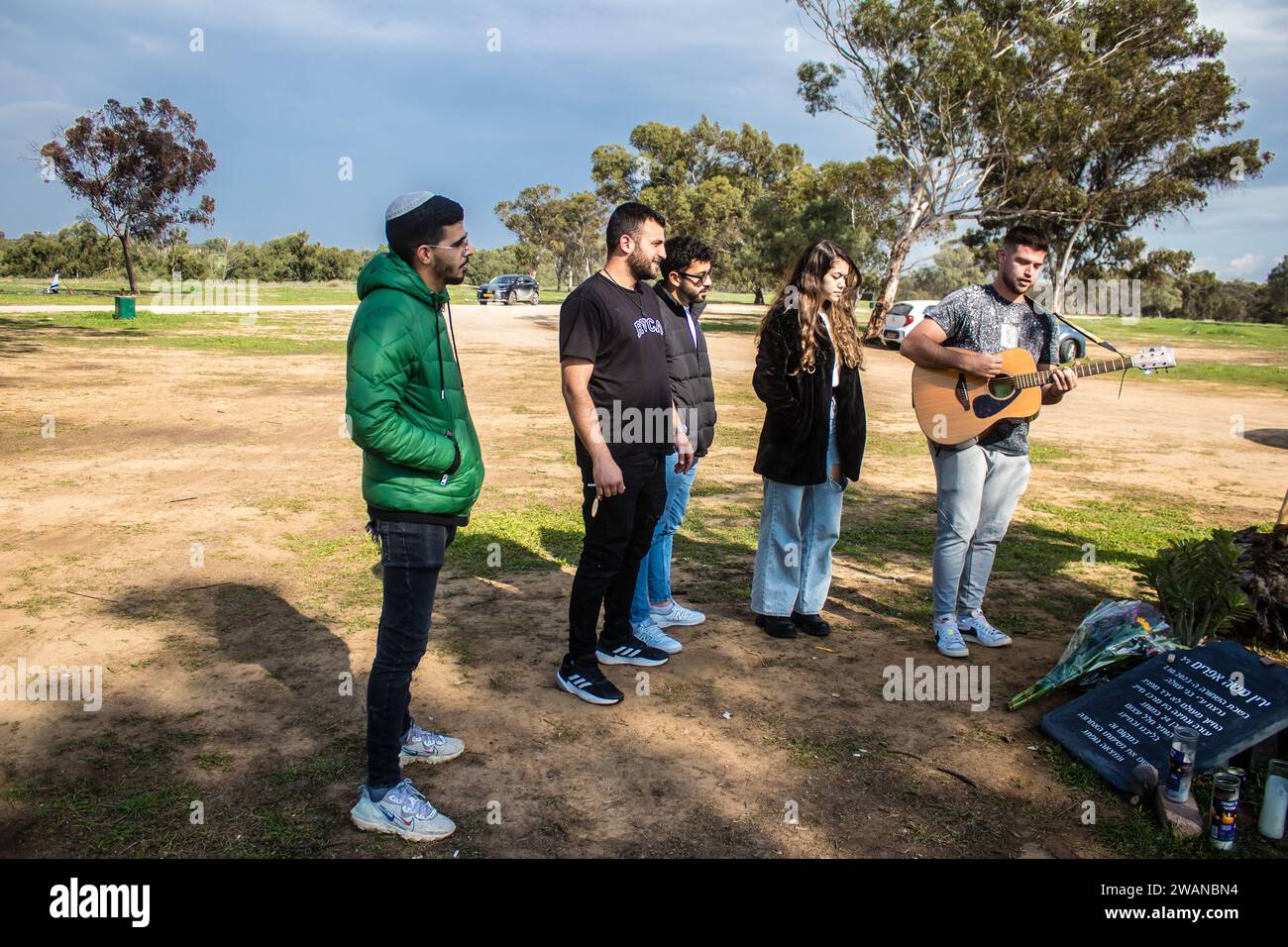 A group of friends gather at the spot where one of their friends, a ...