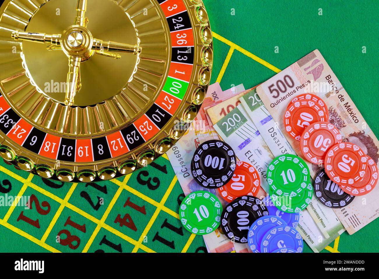 On green gaming table with Mexican banknotes, poker chips, there is ...