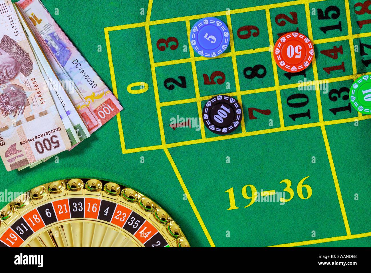 Casino roulette table features Mexican banknotes poker chips on green ...