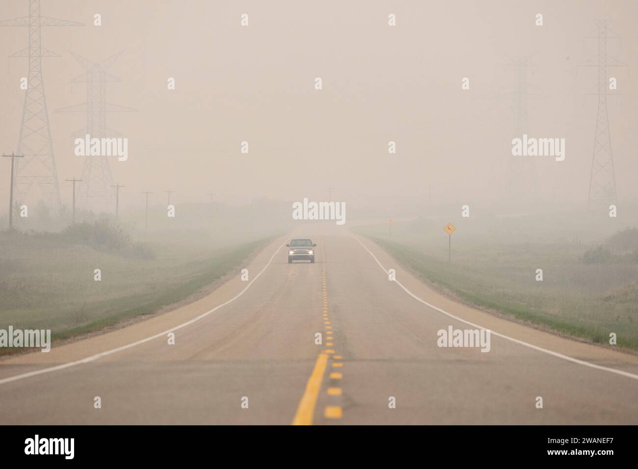 Pickup truck driving through wildfire smoke during 2023 wildfire season ...