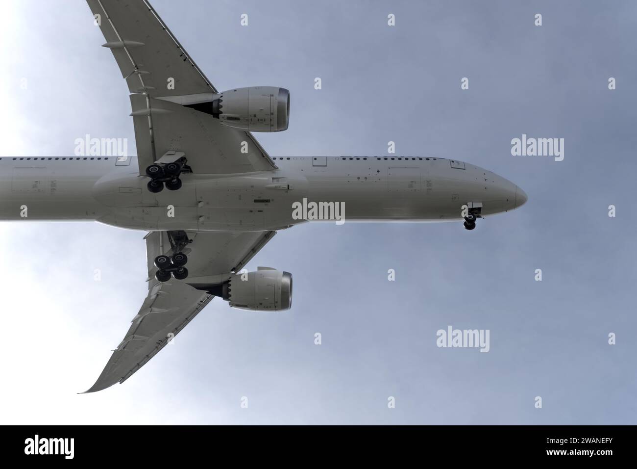 Lower fuselage of a passenger airplane with landing gear deployed and ...