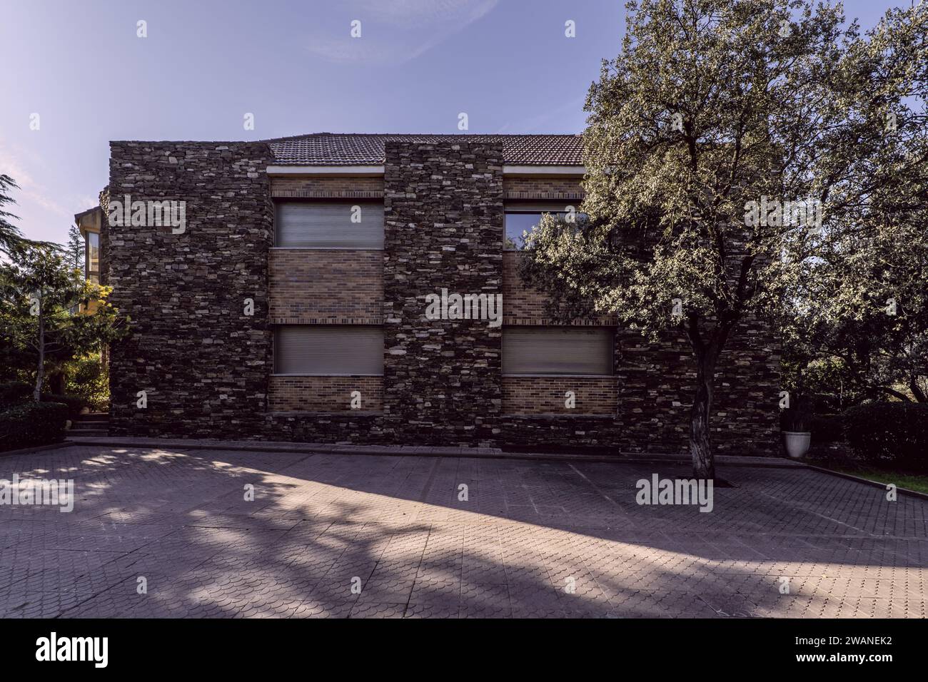 Side facades of single-family residential building with lowered blinds ...
