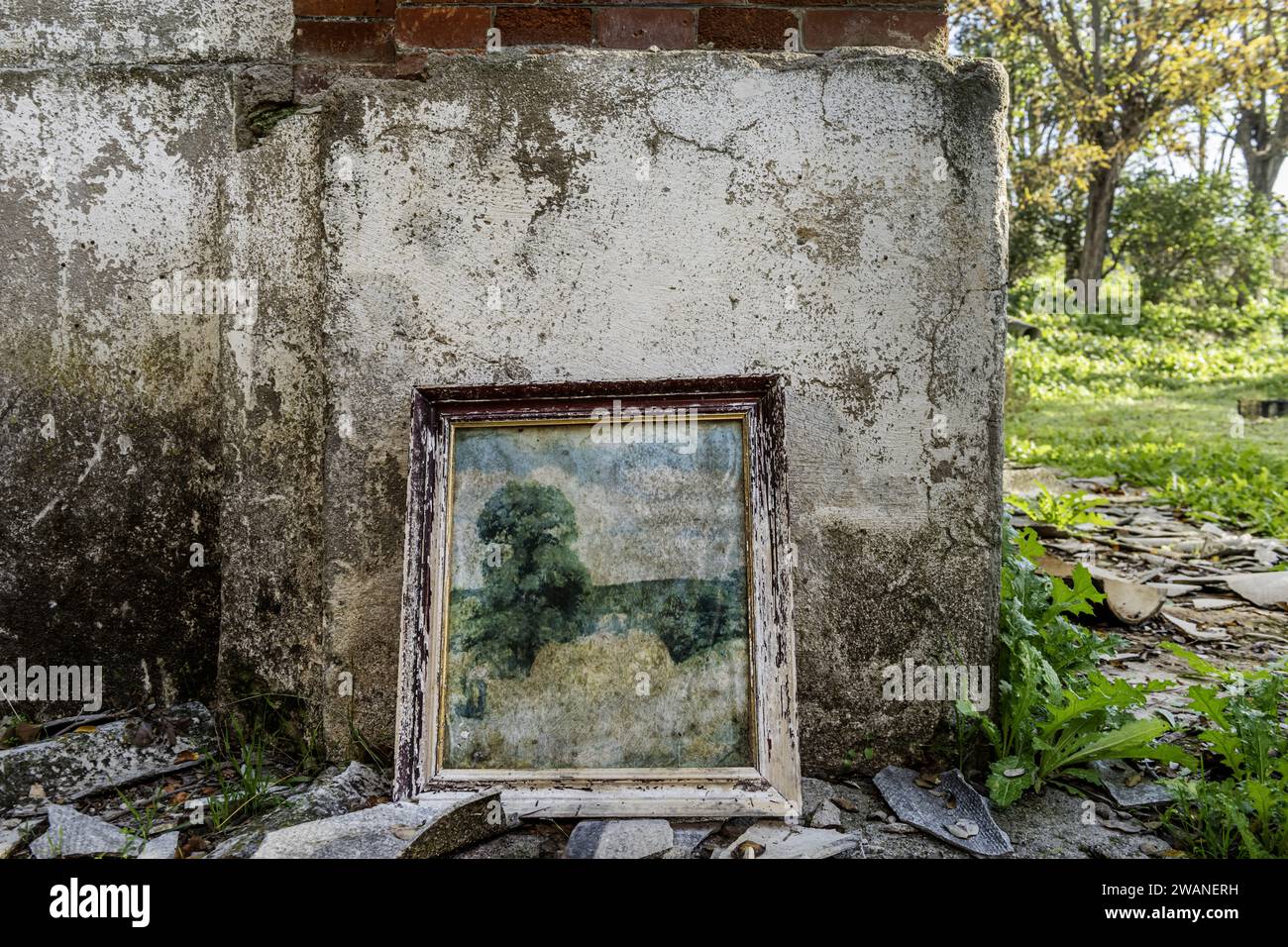 A deteriorated generic painting leaning on the outside of a ruined ...