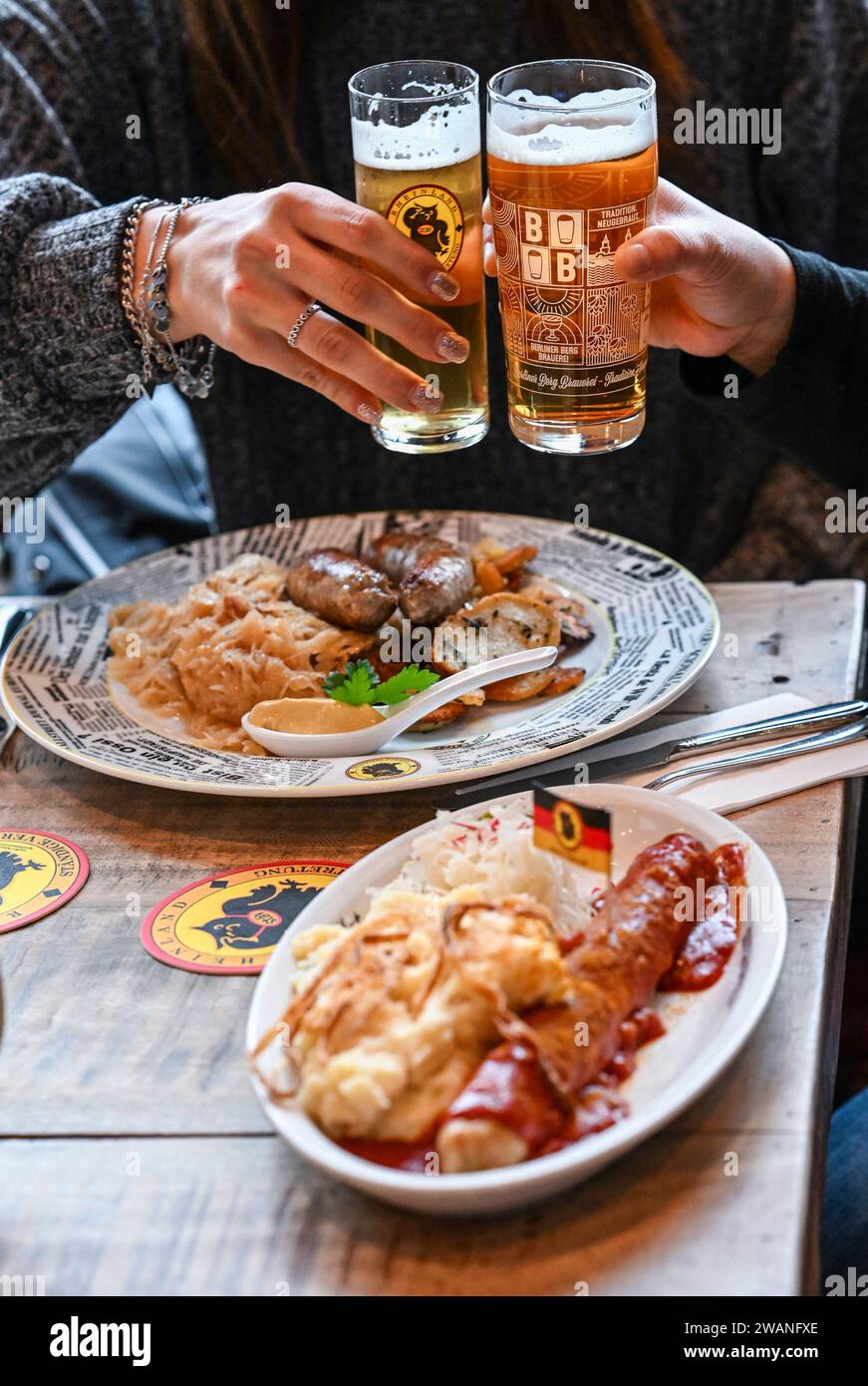 Berlin, Germany. 05th Jan, 2024. Two women eating and drinking in the ...