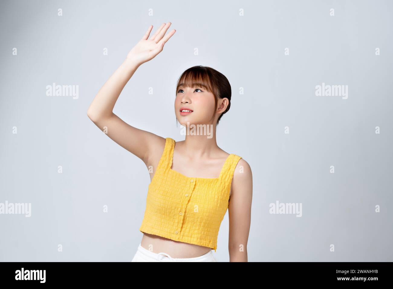 Beautiful Asian young woman hand up cover face protect sun light and UV ...