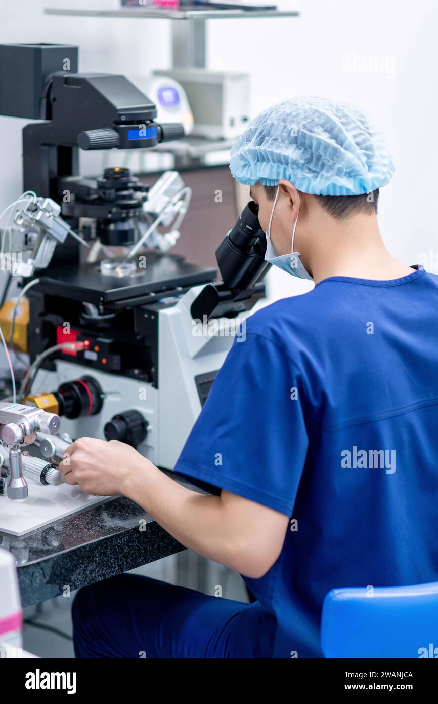 Doctor using IVF micromanipulator with Petri Dish on it for ...