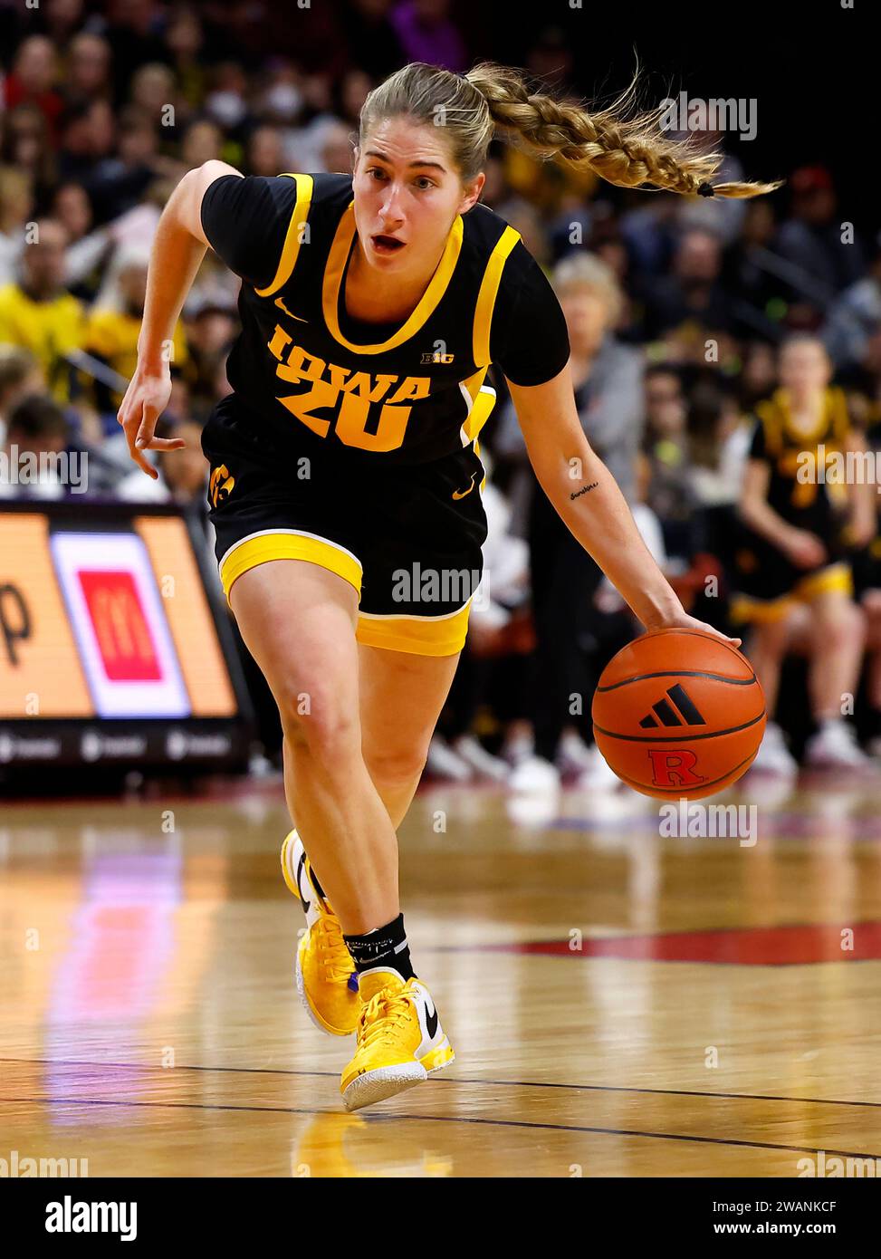 Iowa guard Kate Martin (20) dribbles the ball against the Rutgers ...