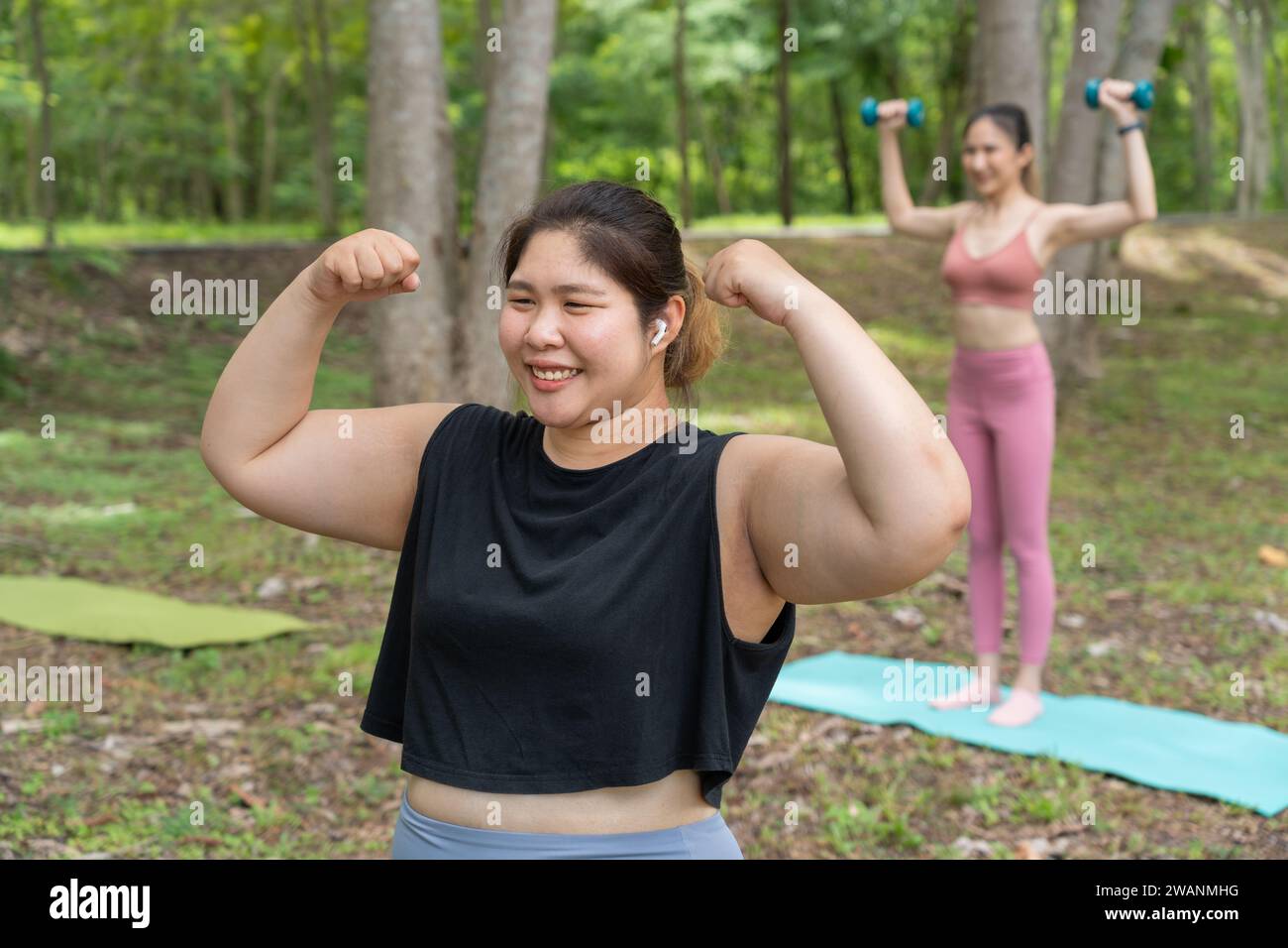 Happy smiling plus size Asian woman putting her arms up to show her ...