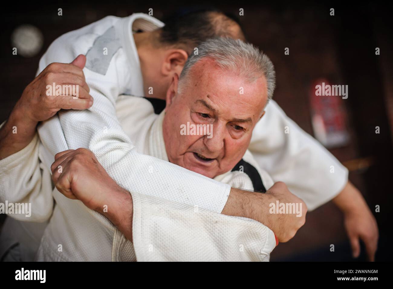Close-up portrait of judo sensei master instructor in traditional gi ...