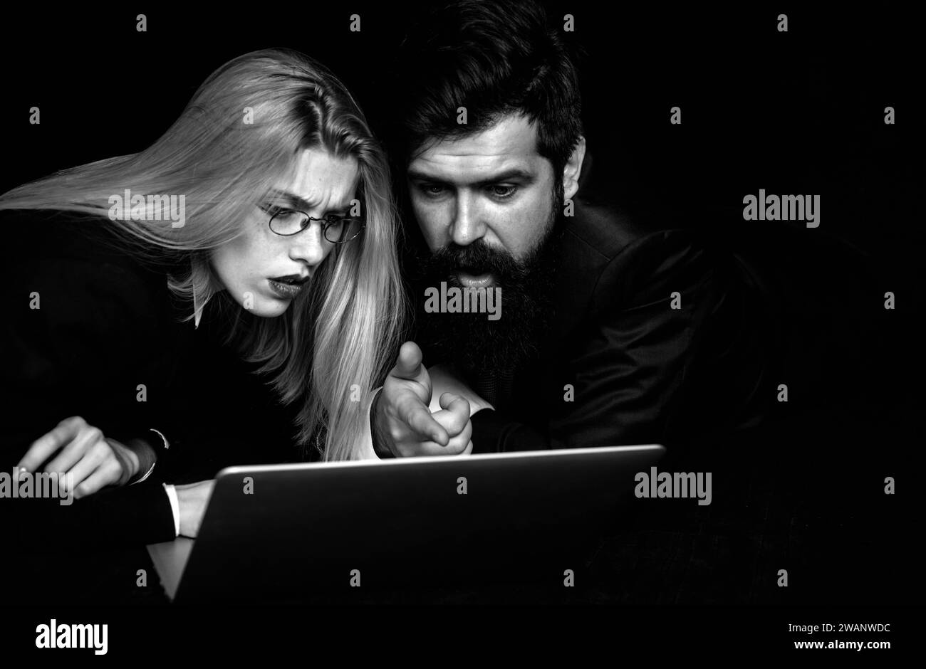 Two business partners working with laptop together. Couple guy and girl ...