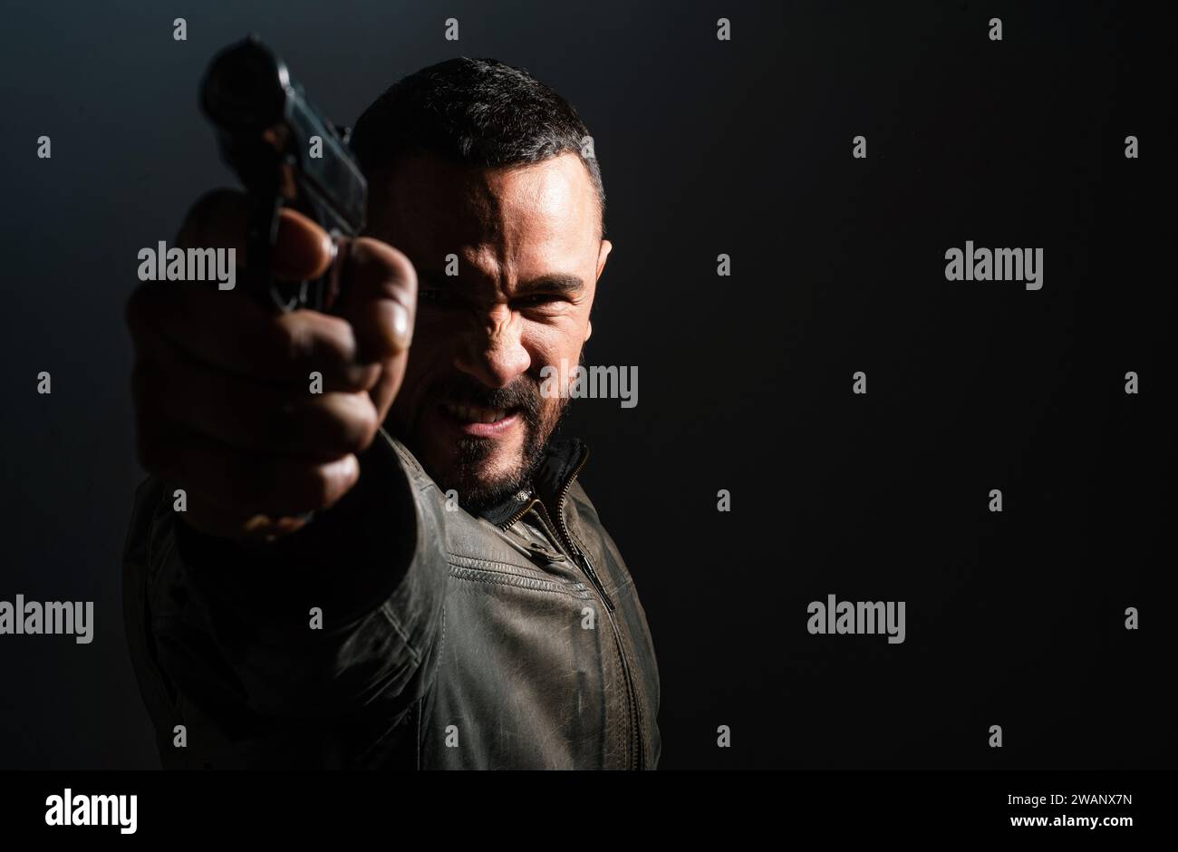 Brutal angry gang man lifestyle. Gangster in action, killer aiming ...