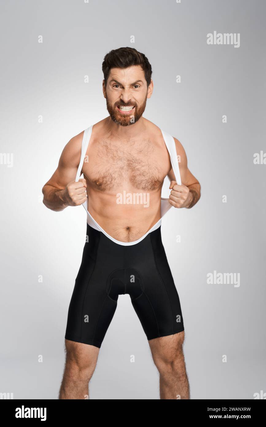 Angry bearded wrestler in black and white singlet, while posing to ...