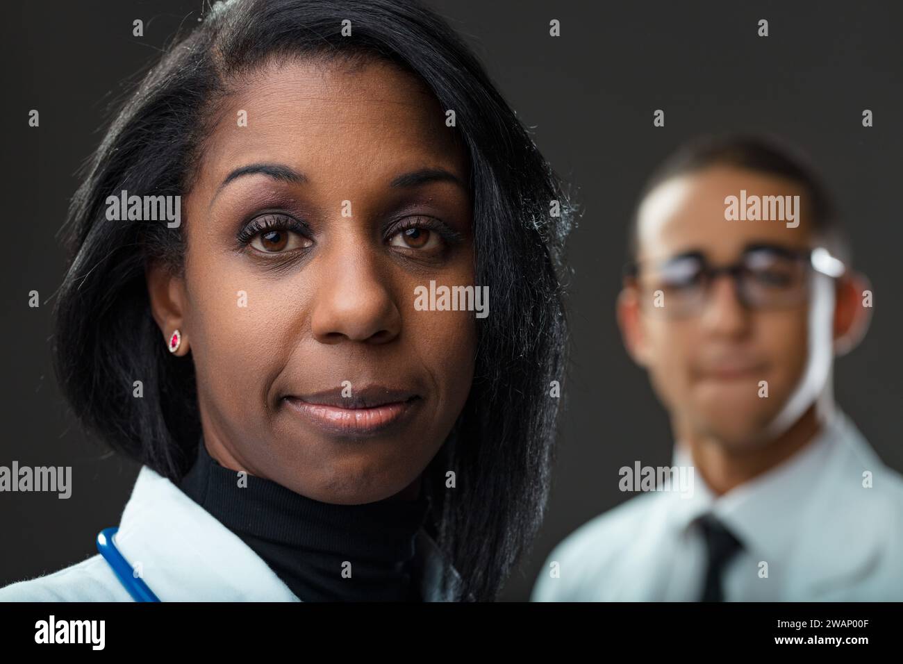 Sharp focus on a female doctor’s face reveals determination, her ...