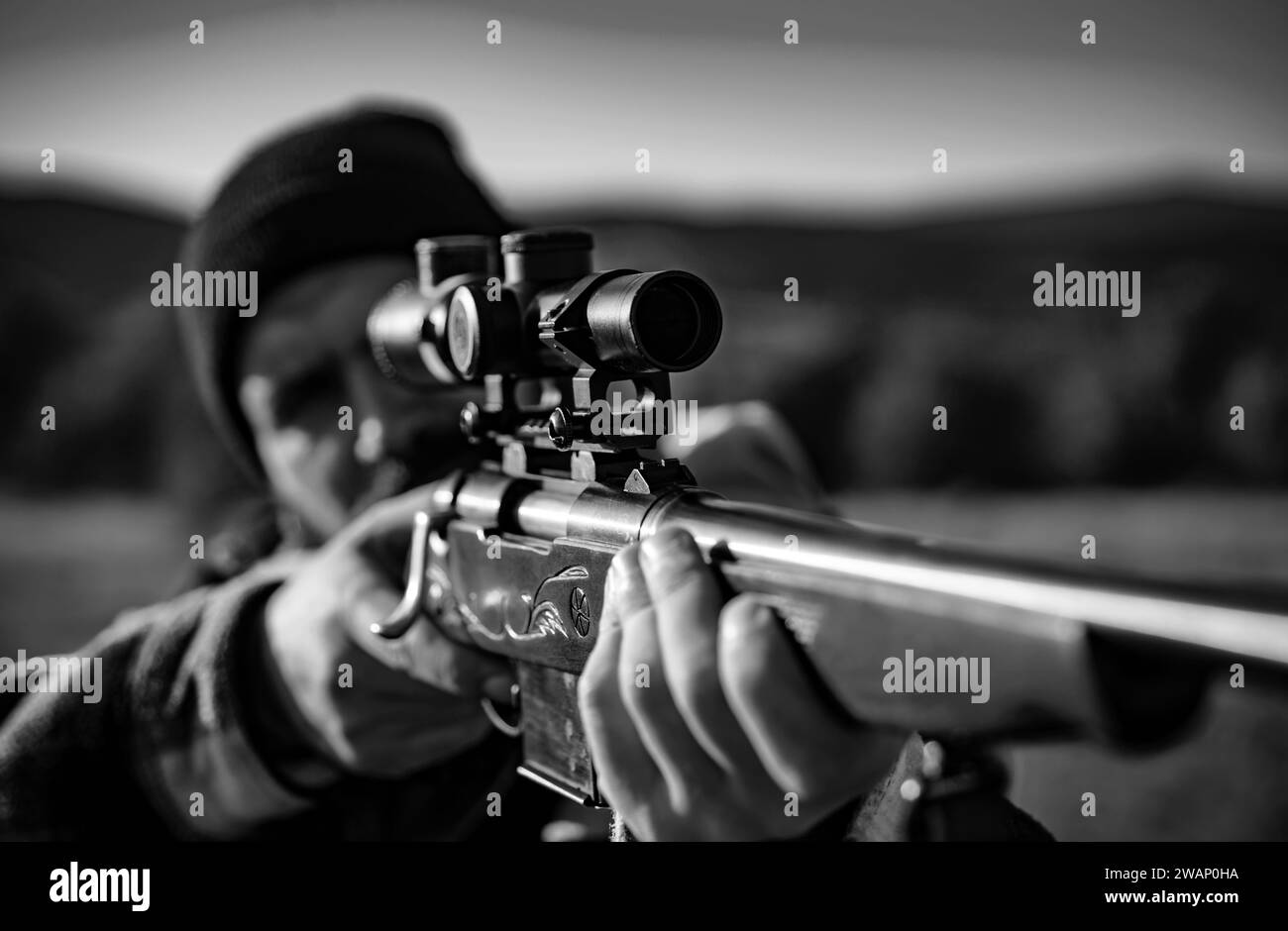 Hunter with Powerful Rifle with Scope Spotting Animals. Hunter with ...