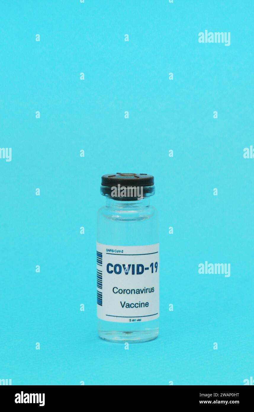 Vertical photo of an empty glass bottle from the Covid-19 vaccine on a ...
