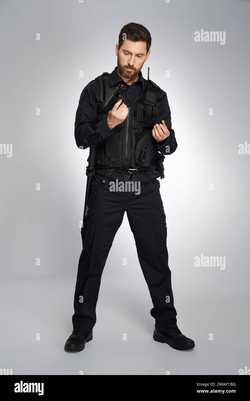 Collected caucasian police officer reloading weapon, getting ready to ...