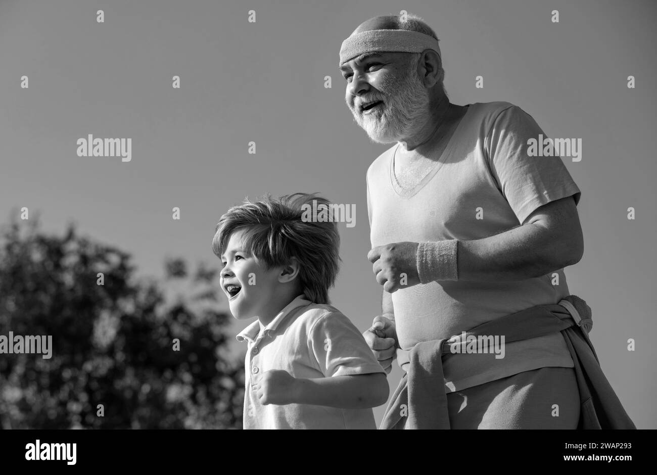Grandpa and grandson running in park for good health. Jog and run ...