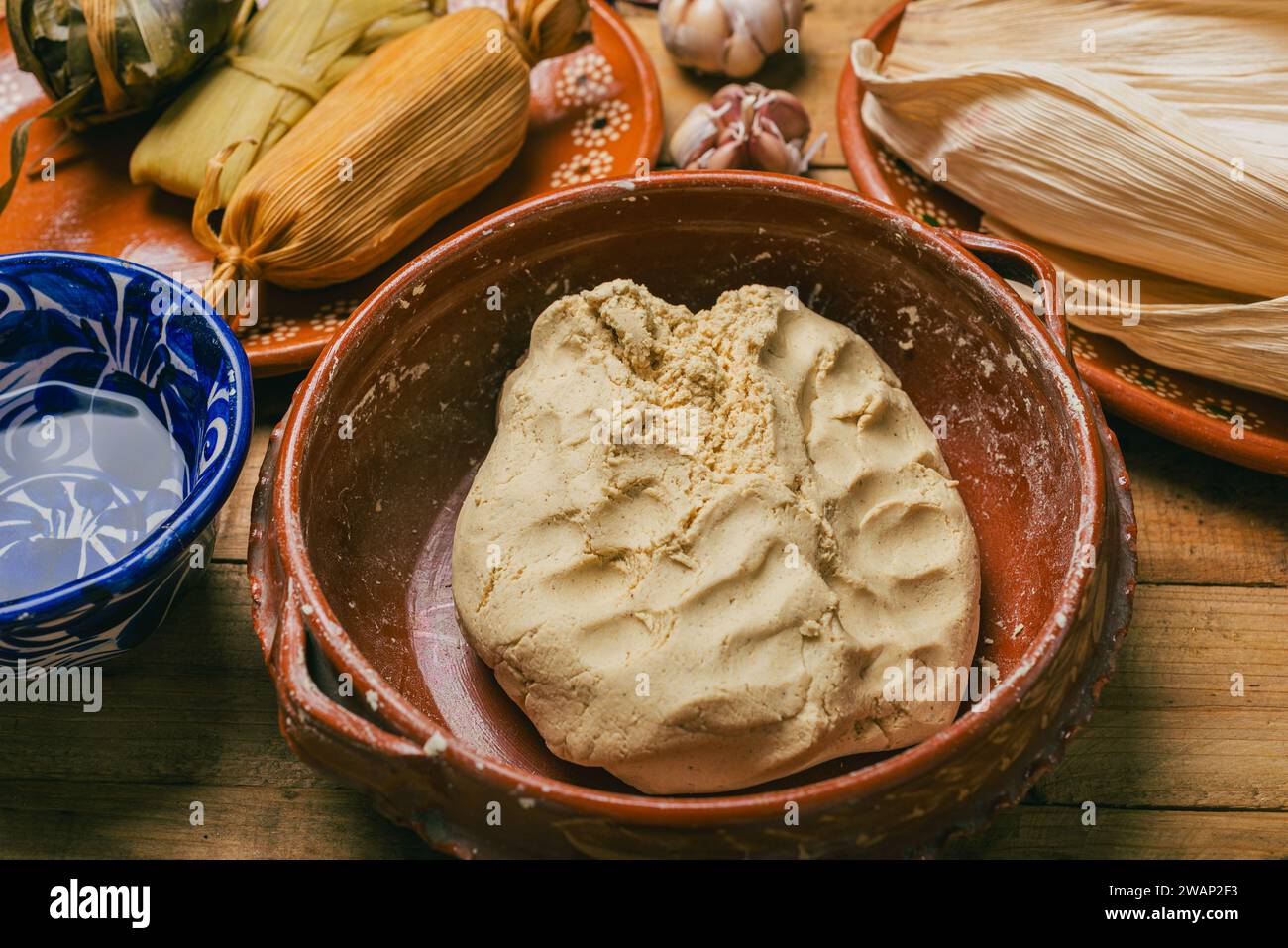 Corn dough nixtamalized in a clay pot to prepare tamales. Typical ...