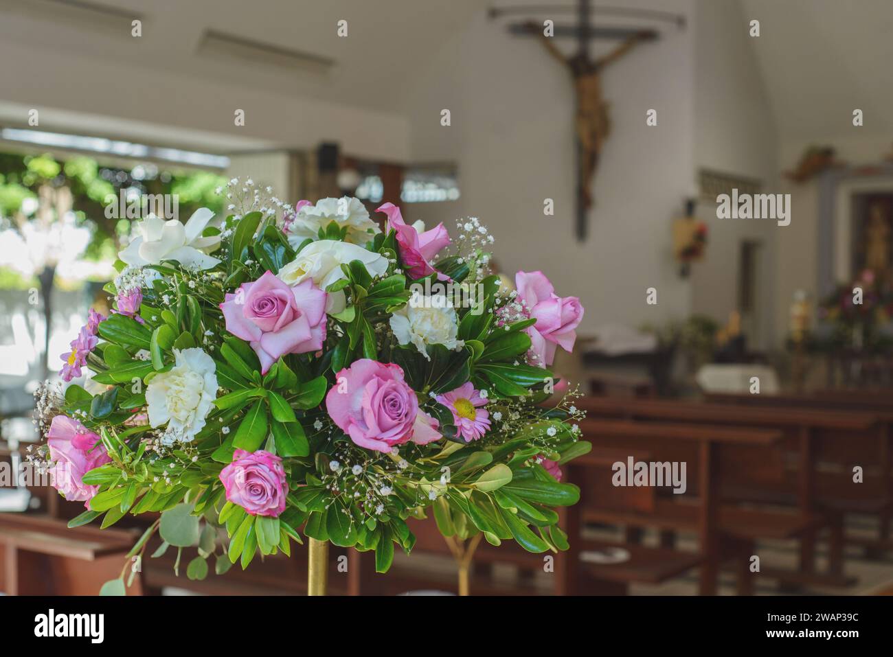Bouquet of flowers with religious images in the background. Interior of ...
