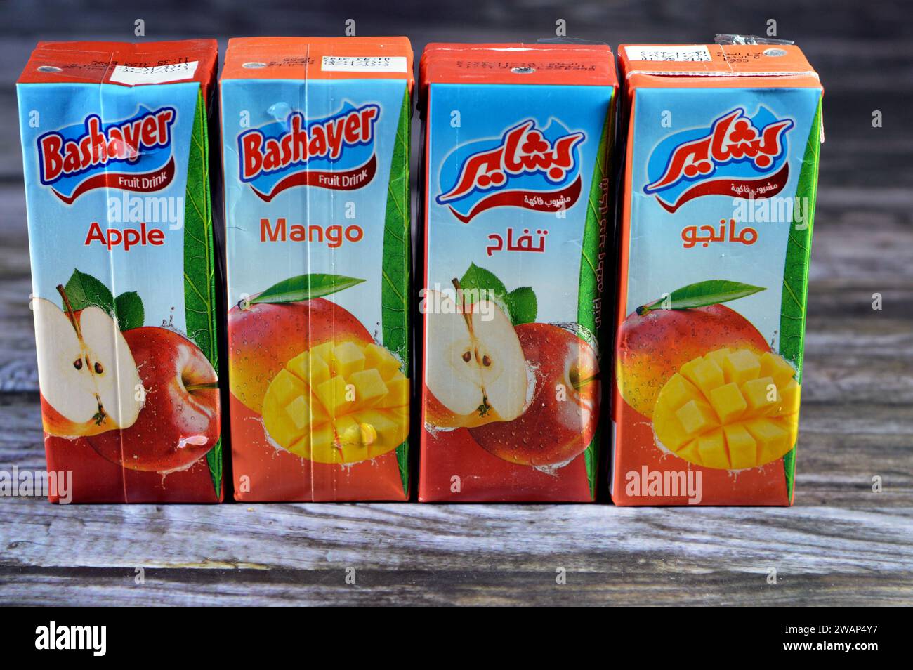 Cairo, Egypt, January 2 2024: Bashayer apple fruit drink and Mango Juice, refreshments with a ...