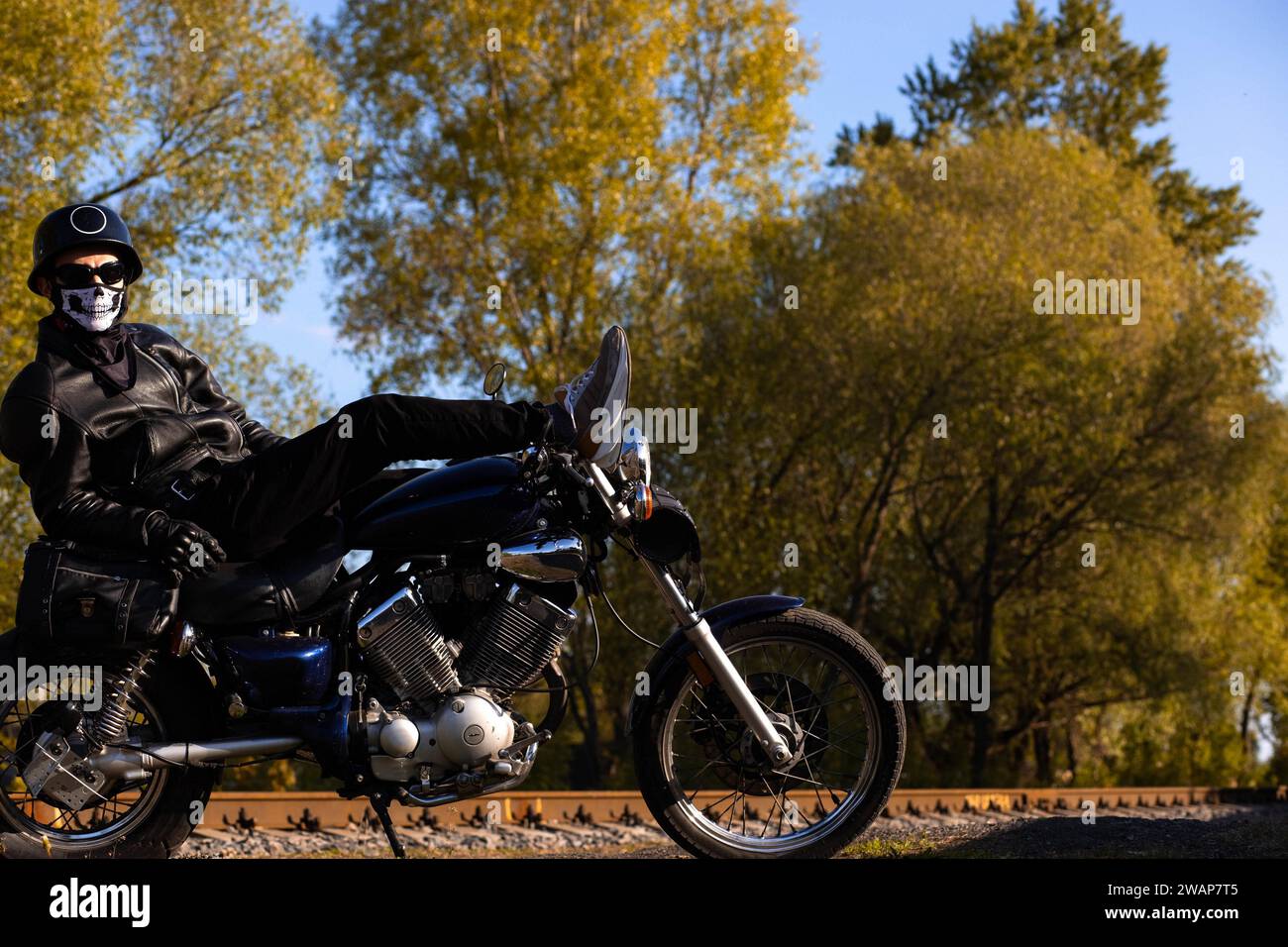 Motorcyclist in a leather jacket and helmet vintage custom motorcycle ...