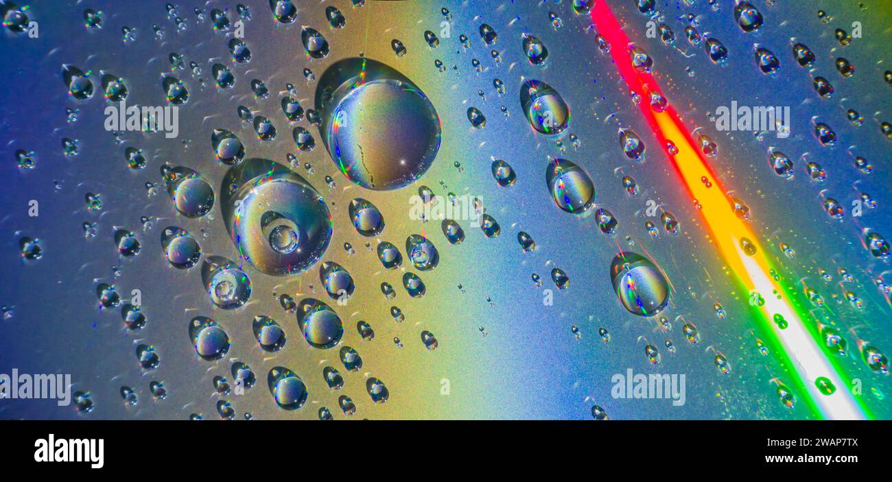 Beautiful closeup of water droplets floating on blueish silver ...