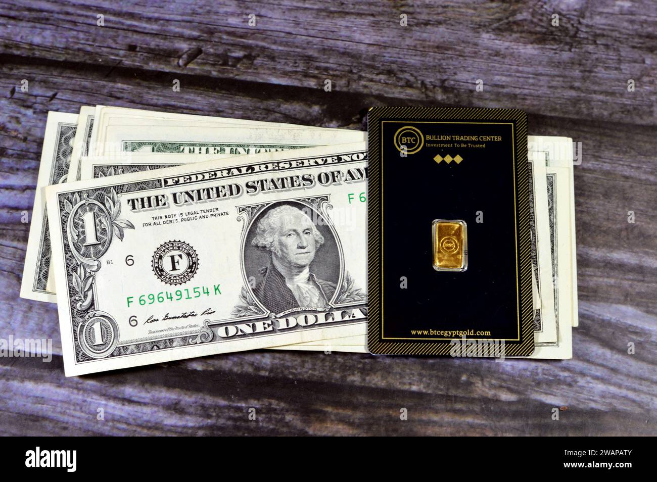 Cairo, Egypt, January 2 2024: American dollars and 24K karat BTC ...