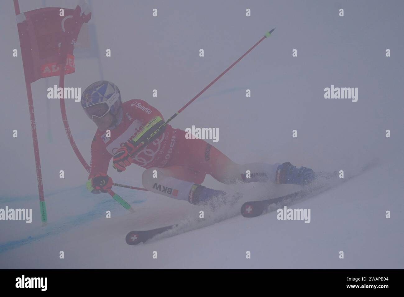 Switzerland's Marco Odermatt speeds down the course through the fog ...