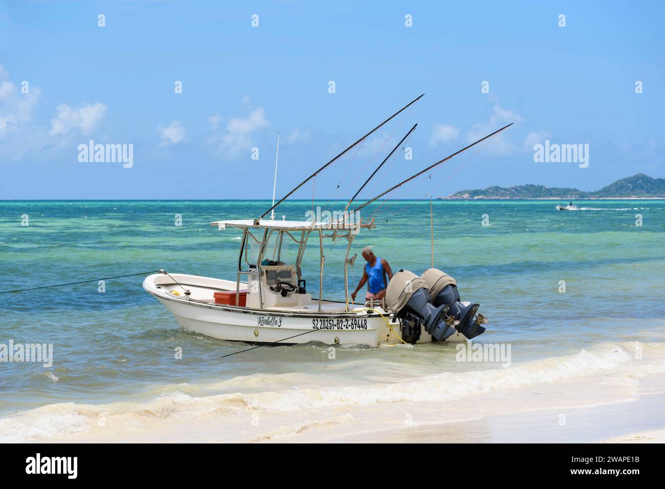 Fishing boats moored off Grand Anse beach on Praslin Island, Seychelles ...