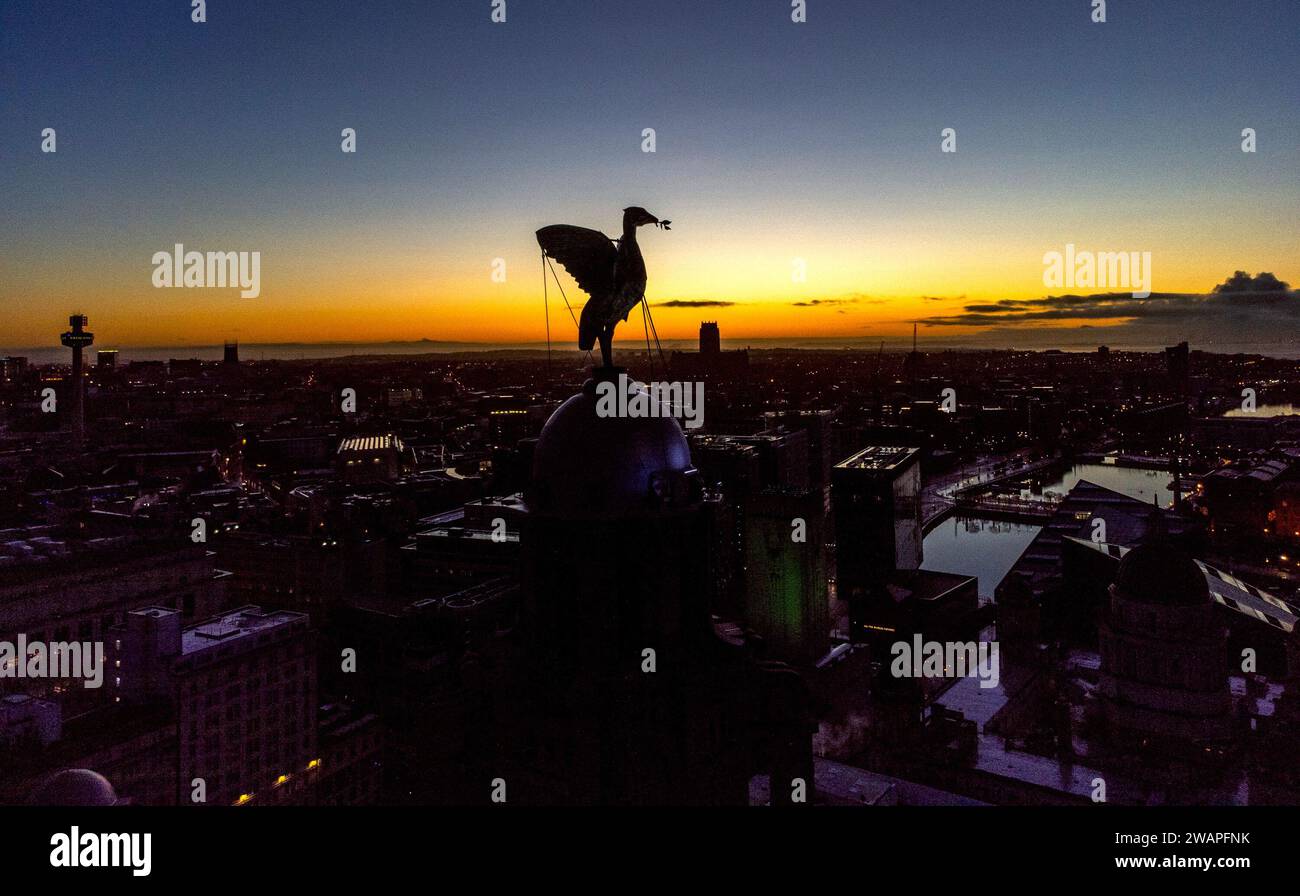 The sun rises behind one of the Liver Birds, sat atop of the Royal ...