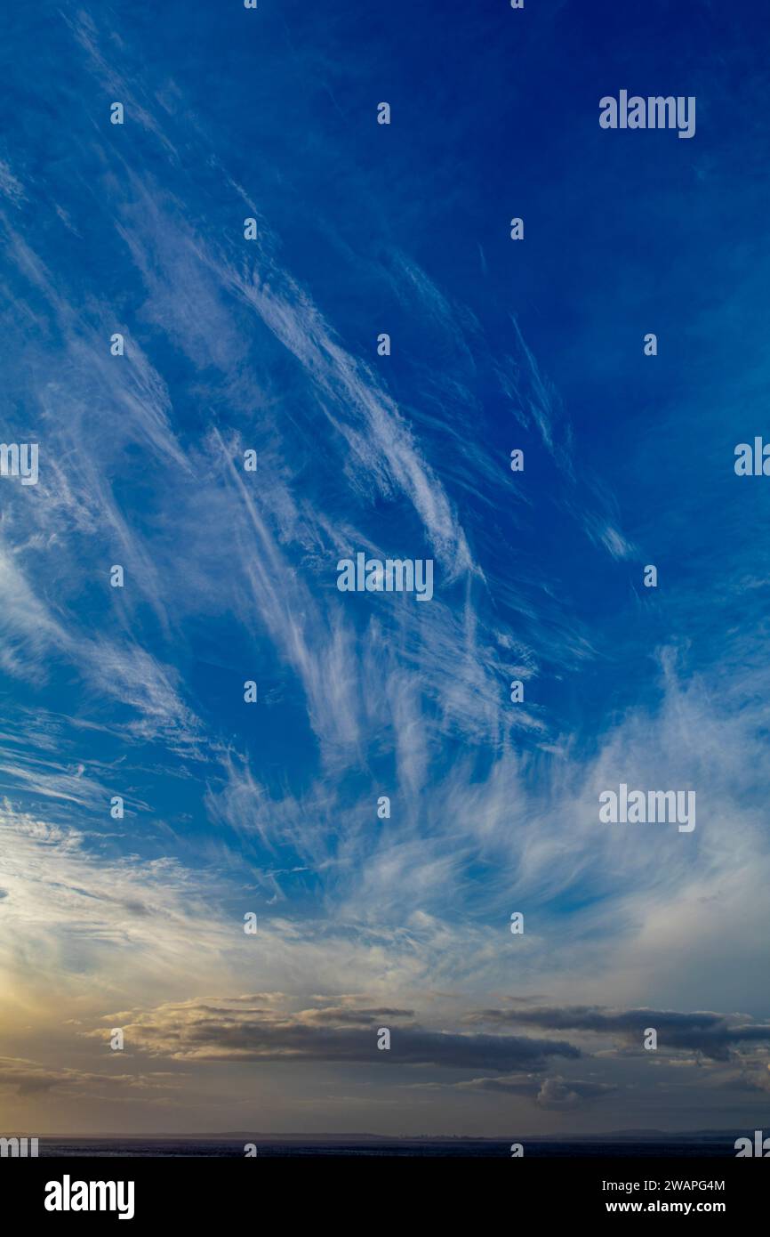 High altitude clouds catching some light from the setting sun Stock ...