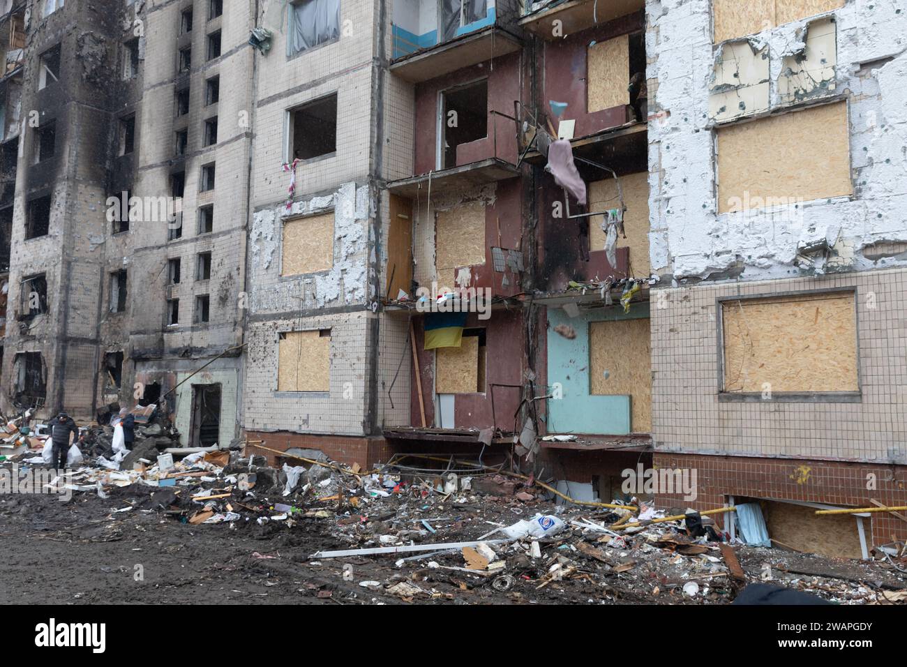 The facade of a building damaged by a Russian missile blast. Piles of ...